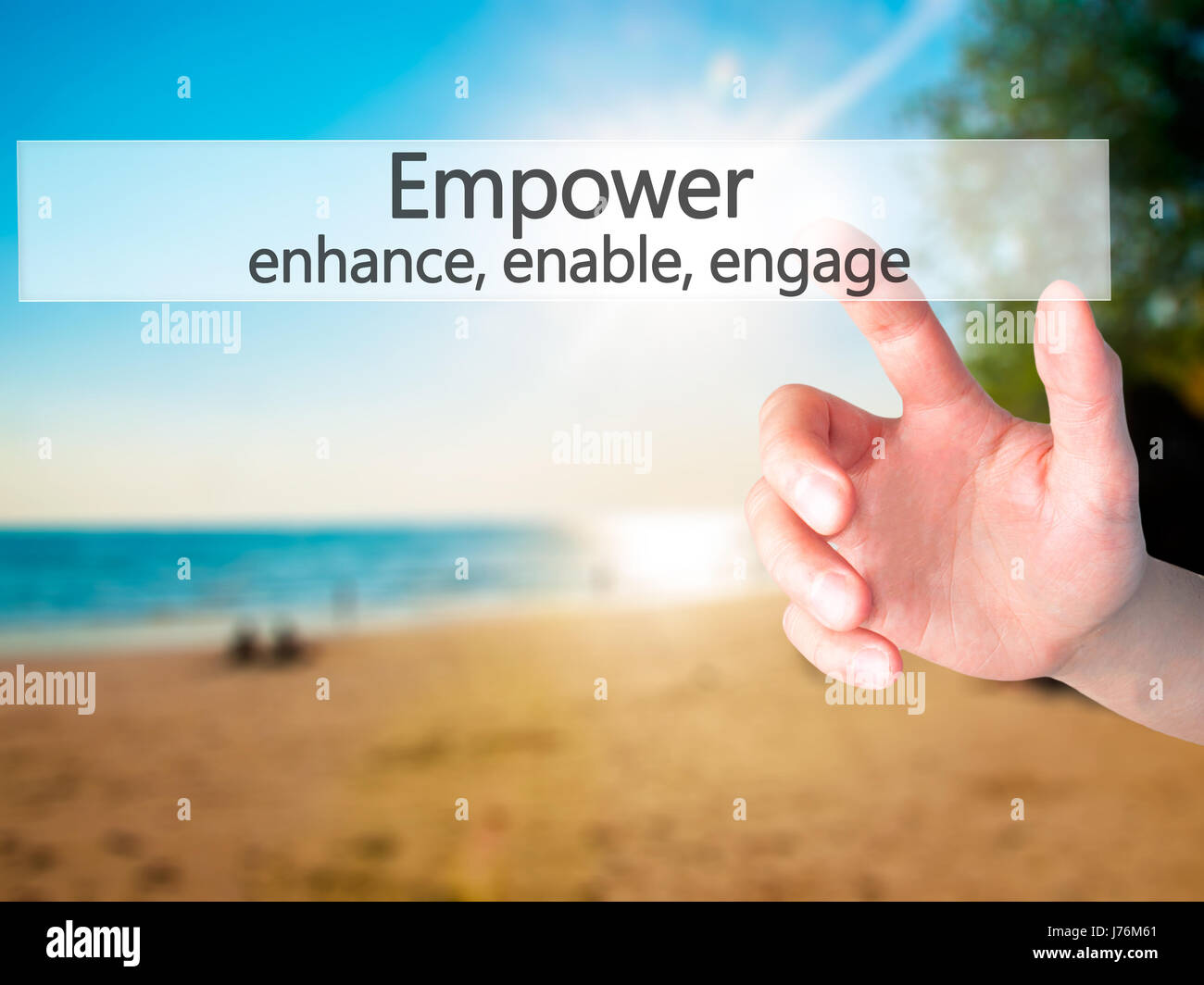 Empower enhance, enable, engage - Hand pressing a button on blurred ...