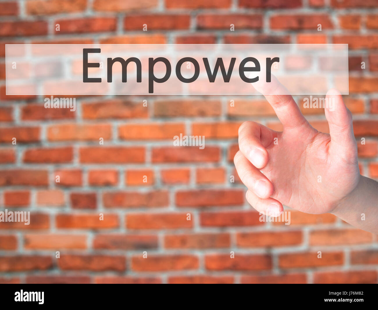 Empower - Hand pressing a button on blurred background concept ...