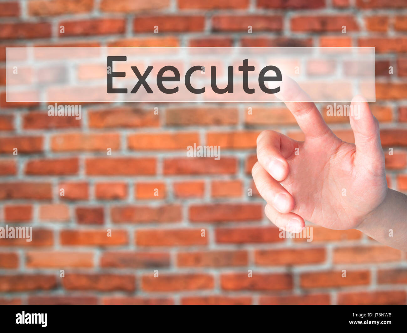 Execute - Hand pressing a button on blurred background concept ...