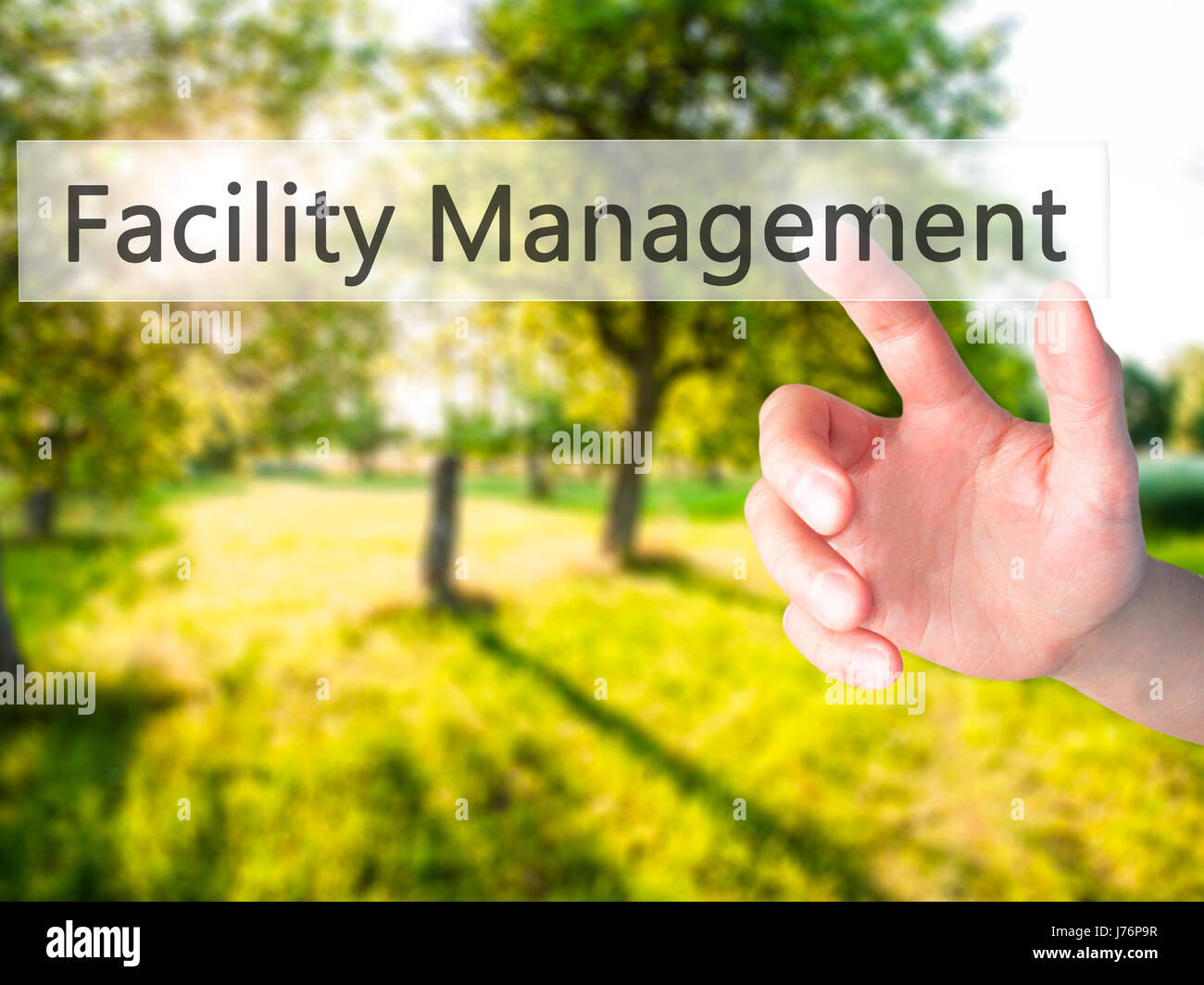 Facility Management - Hand pressing a button on blurred background ...