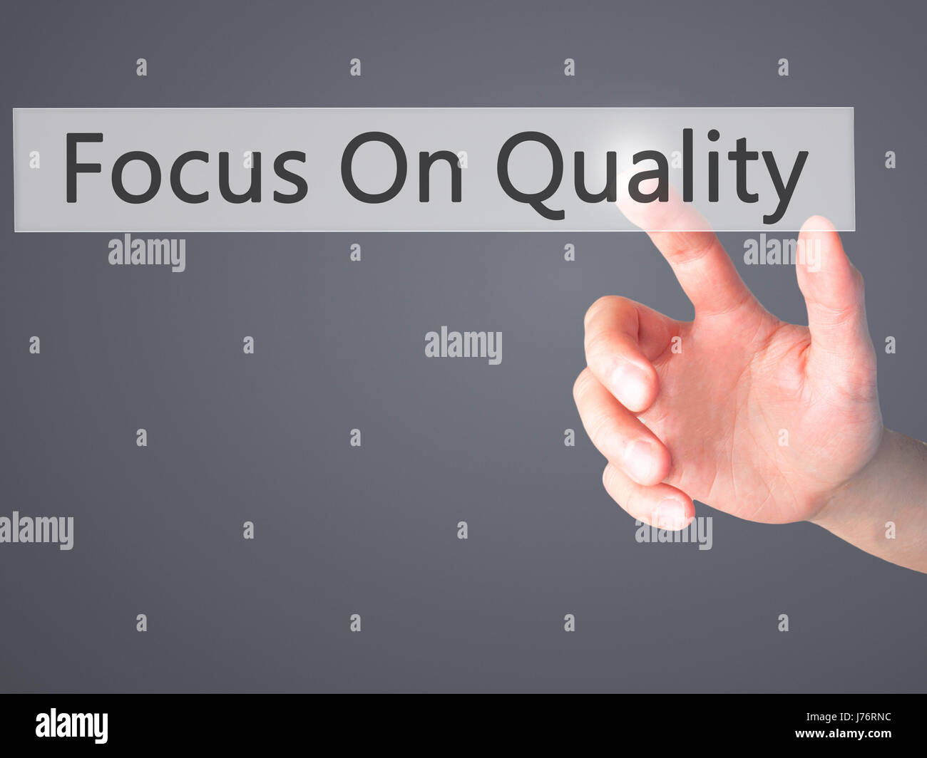 Focus On Quality - Hand pressing a button on blurred background concept ...