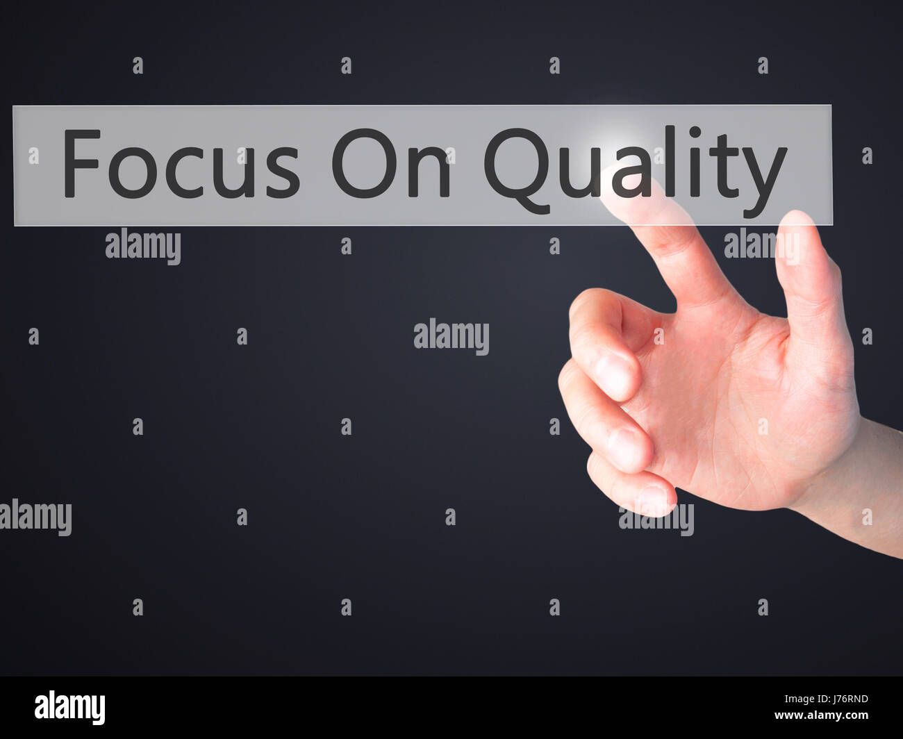 Focus On Quality - Hand pressing a button on blurred background concept ...