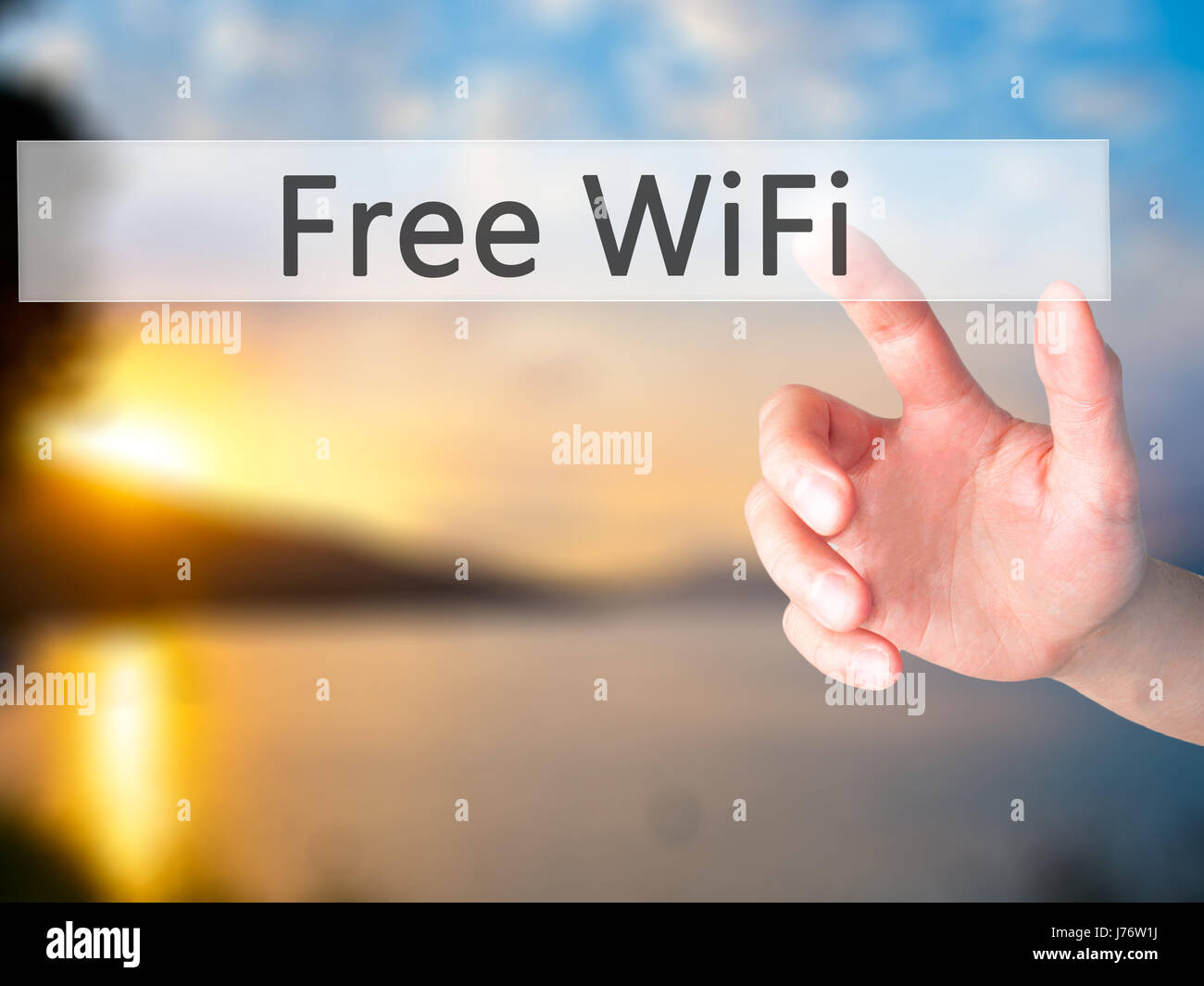Free WiFi - Hand pressing a button on blurred background concept ...