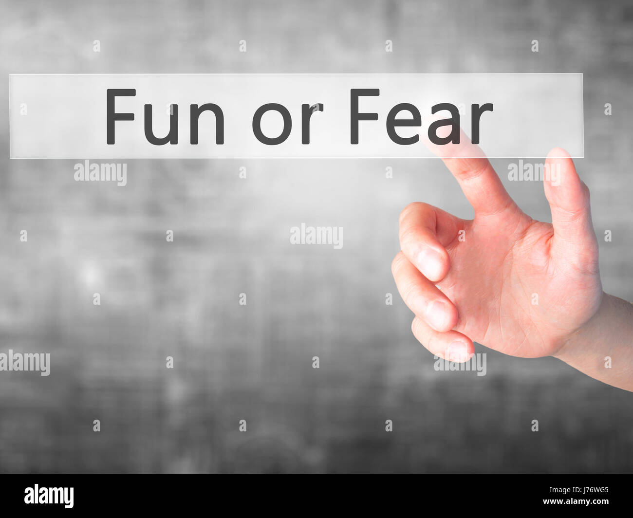 Fun or Fear - Hand pressing a button on blurred background concept ...
