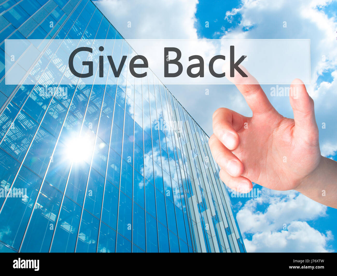 Give Back - Hand pressing a button on blurred background concept ...