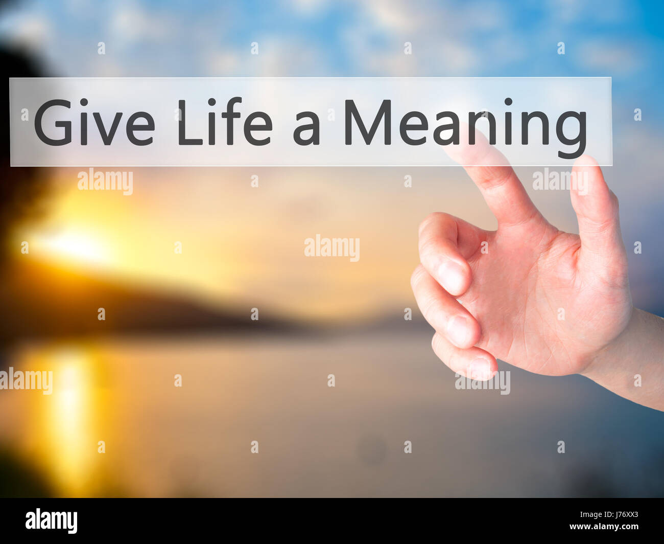 Give Life a Meaning - Hand pressing a button on blurred background ...