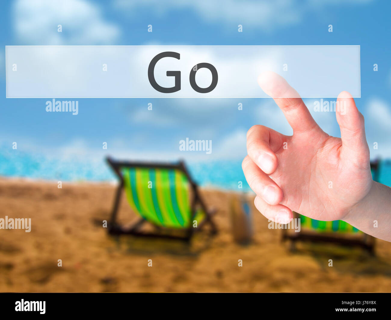 Go - Hand pressing a button on blurred background concept . Business ...