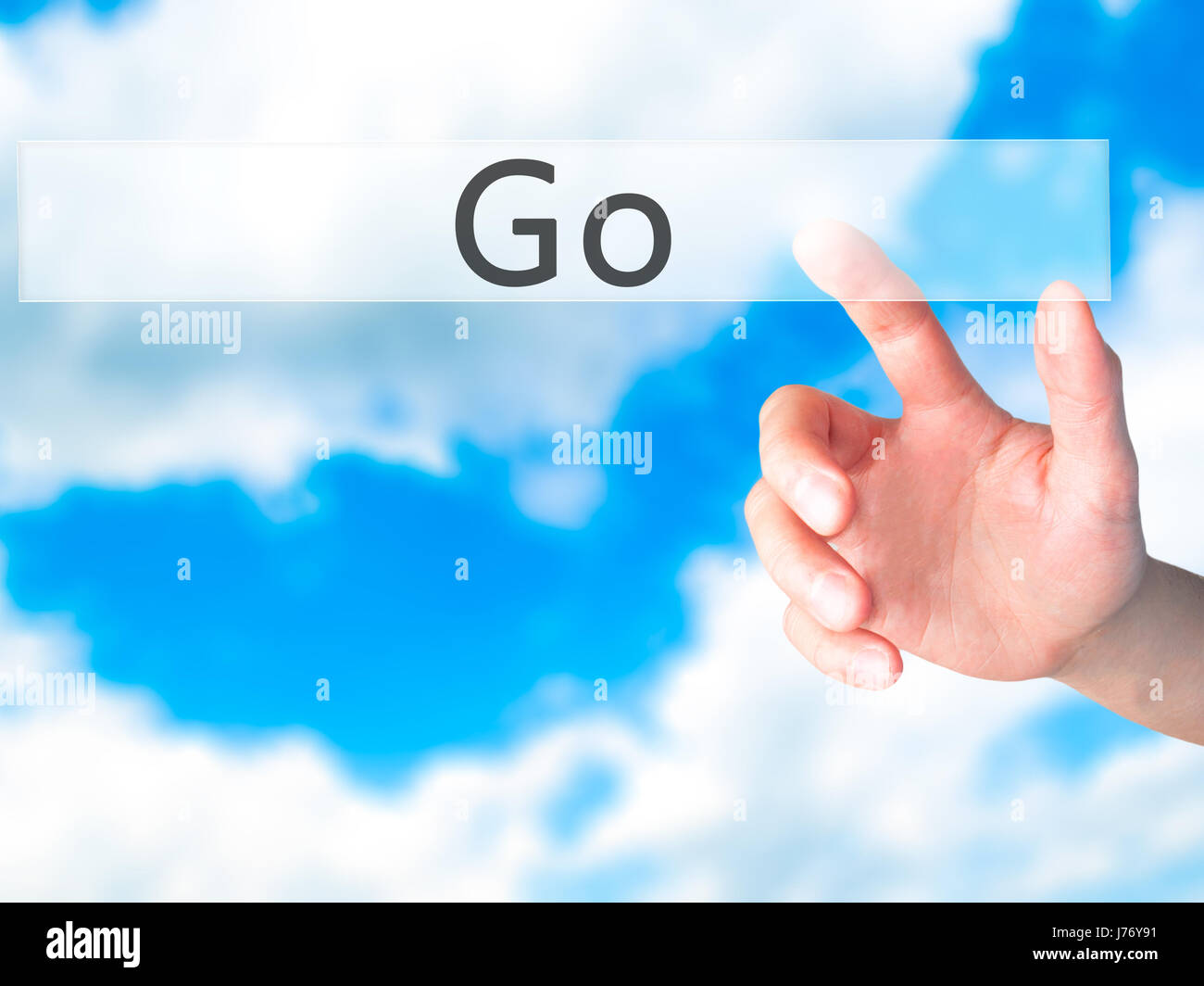 Go - Hand pressing a button on blurred background concept . Business ...