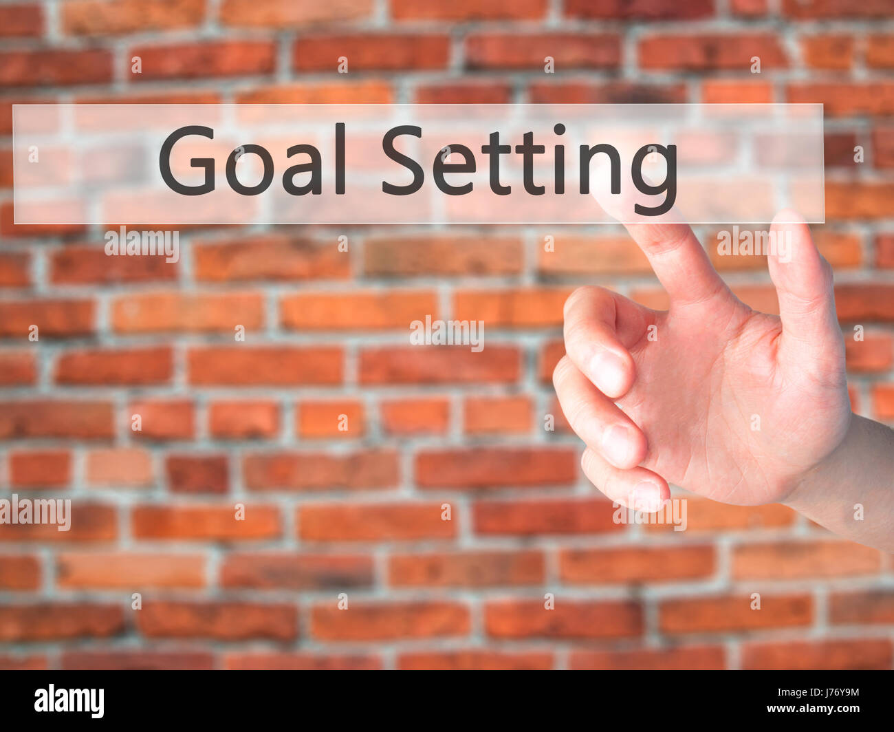Goal Setting - Hand pressing a button on blurred background concept ...