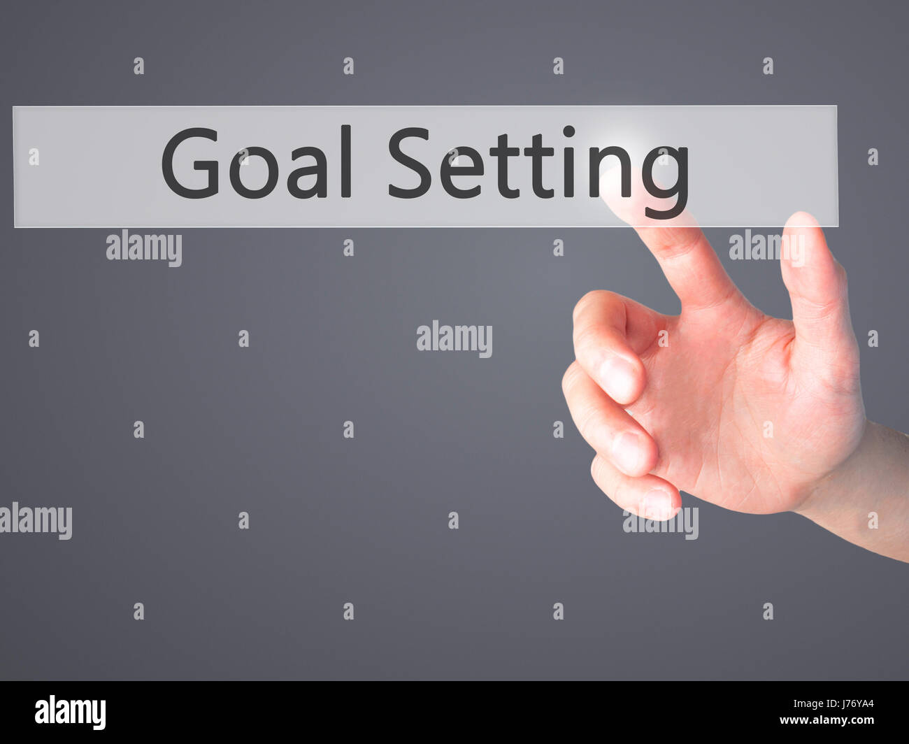 Goal Setting - Hand pressing a button on blurred background concept ...