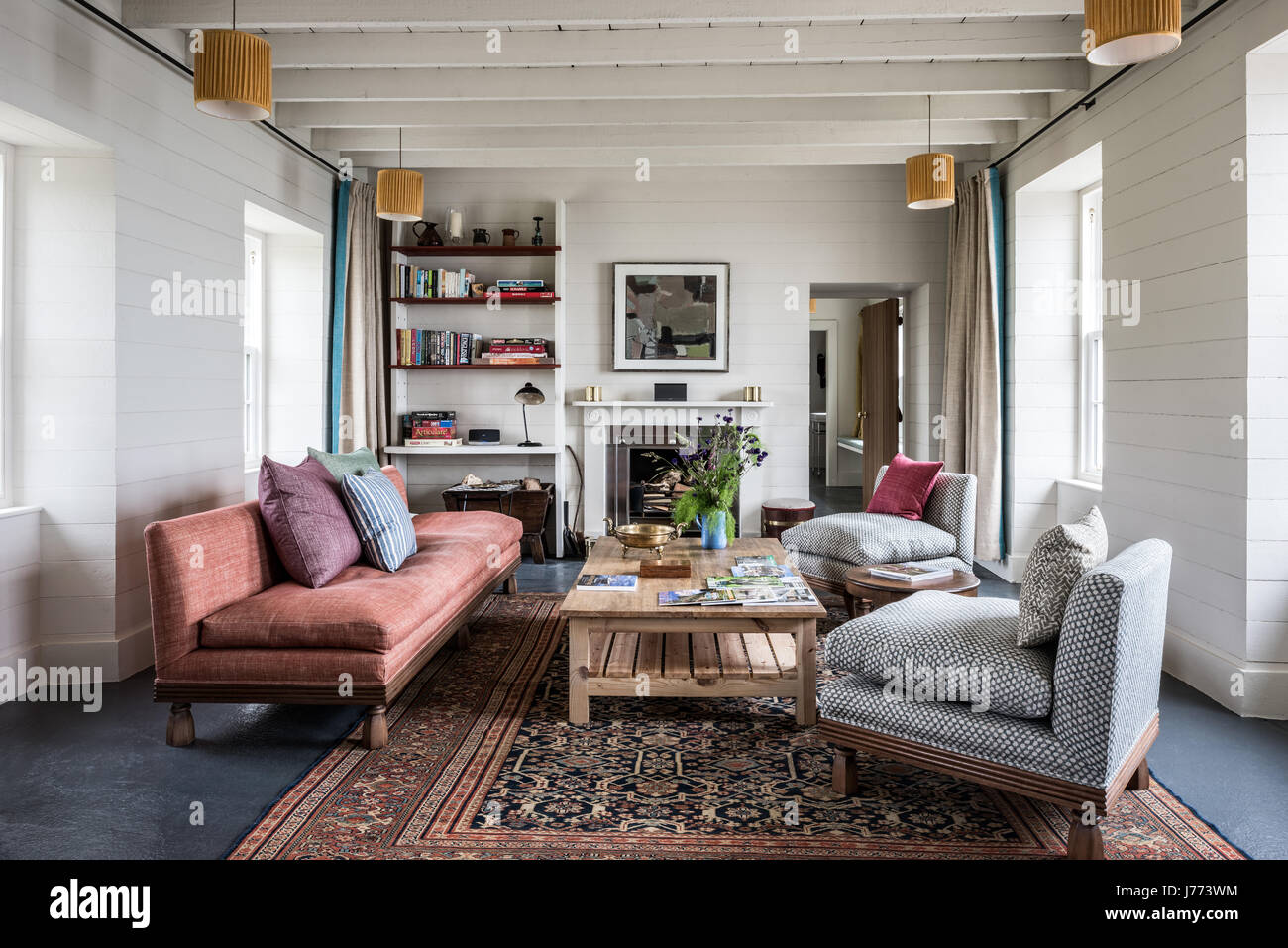Beamed ceiling and furniture in living room of renovated 17th century ...