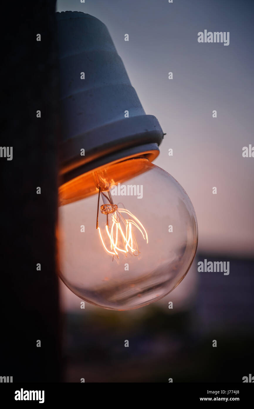 Glowing antique filament light bulb Stock Photo - Alamy
