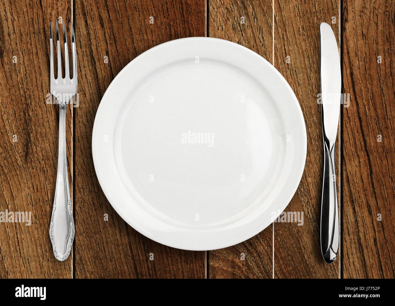 Table setting, empty plate and silverware on wooden table Stock Photo ...