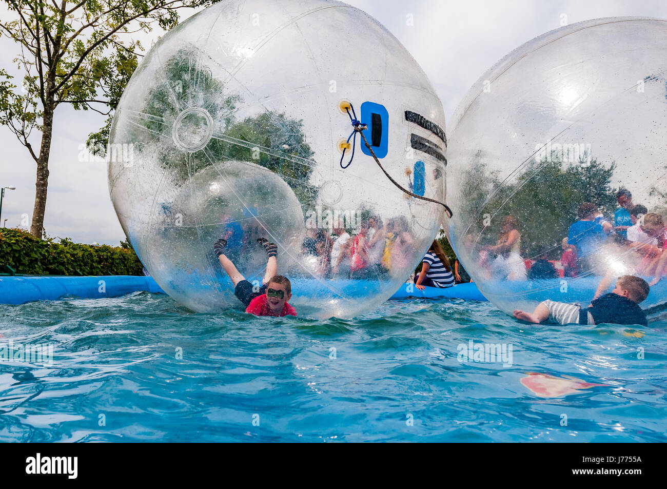 Children playing on floating giant balls Stock Photo - Alamy