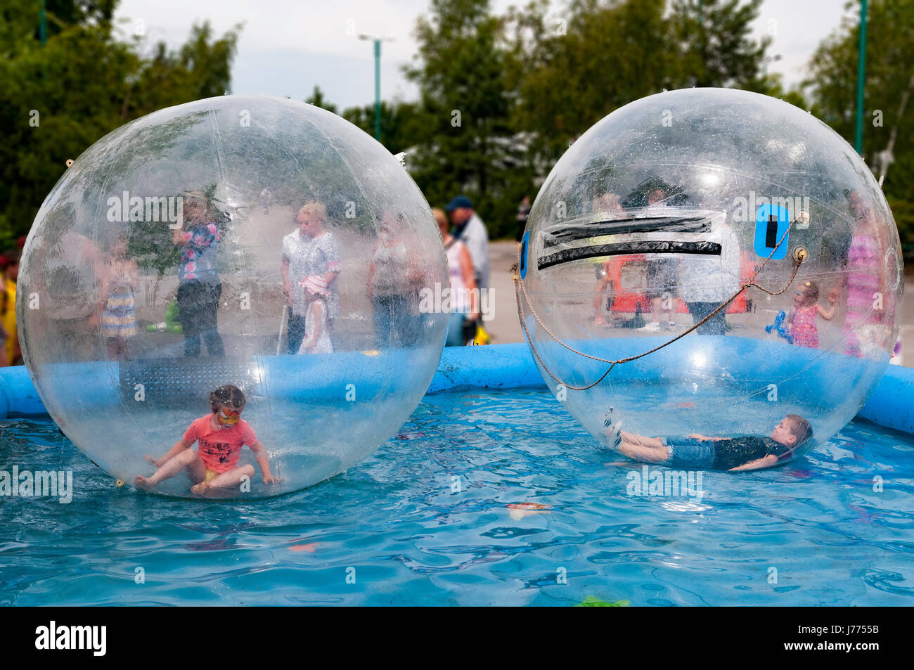 Children playing on floating giant balls Stock Photo - Alamy