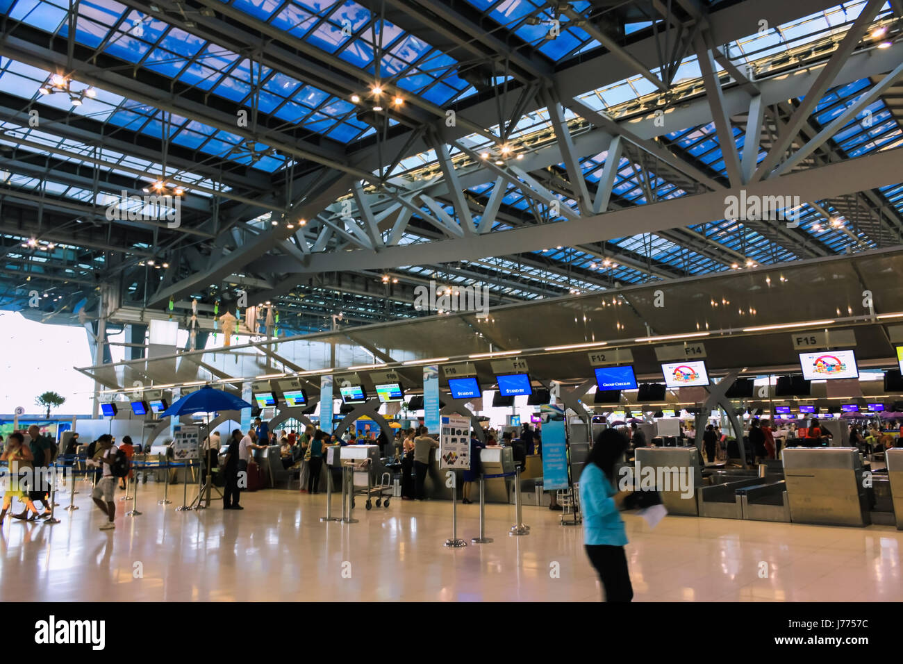 Passengers in an international airport terminal, traveling and ...