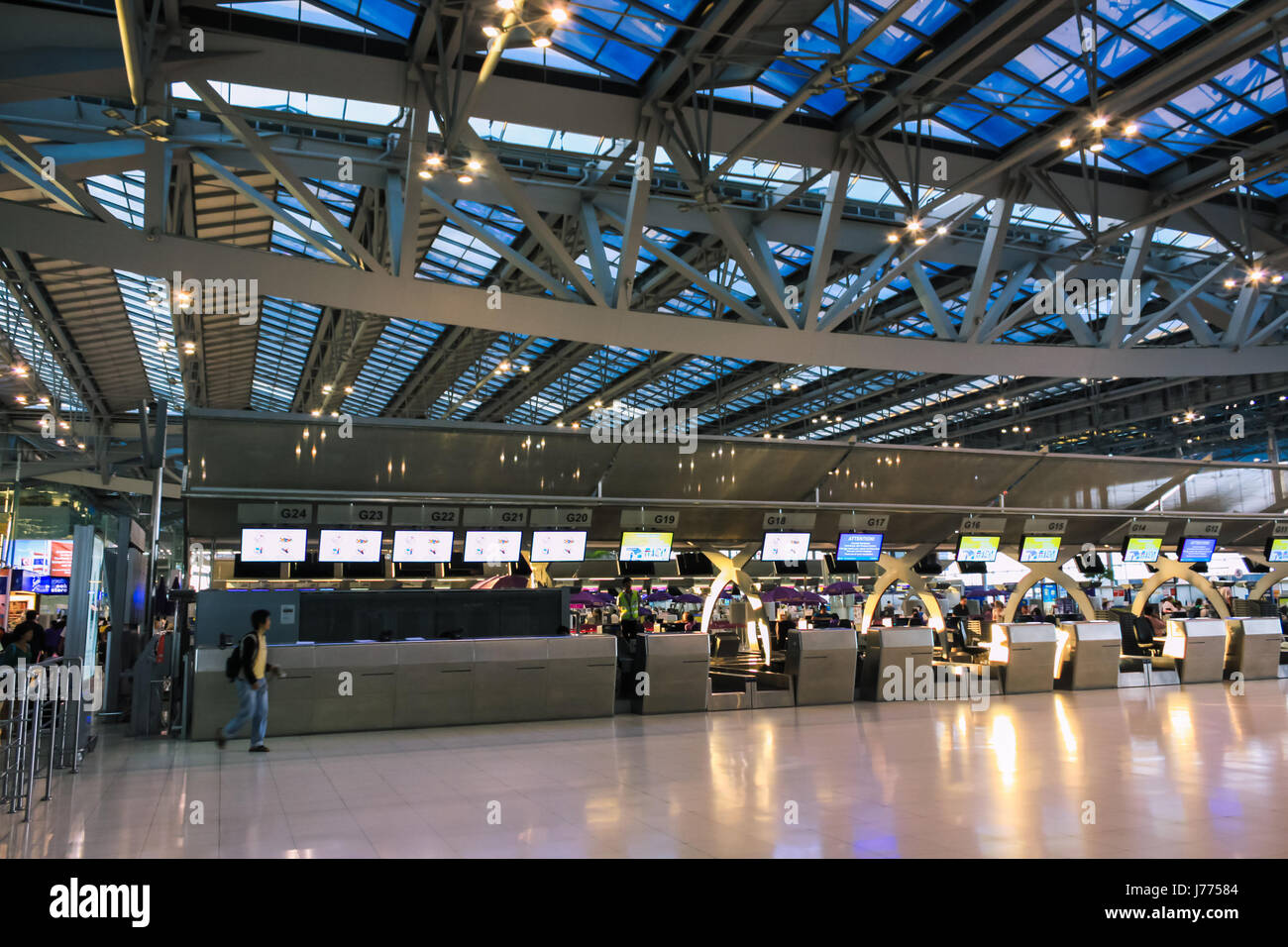 Passengers in an international airport terminal, traveling and ...