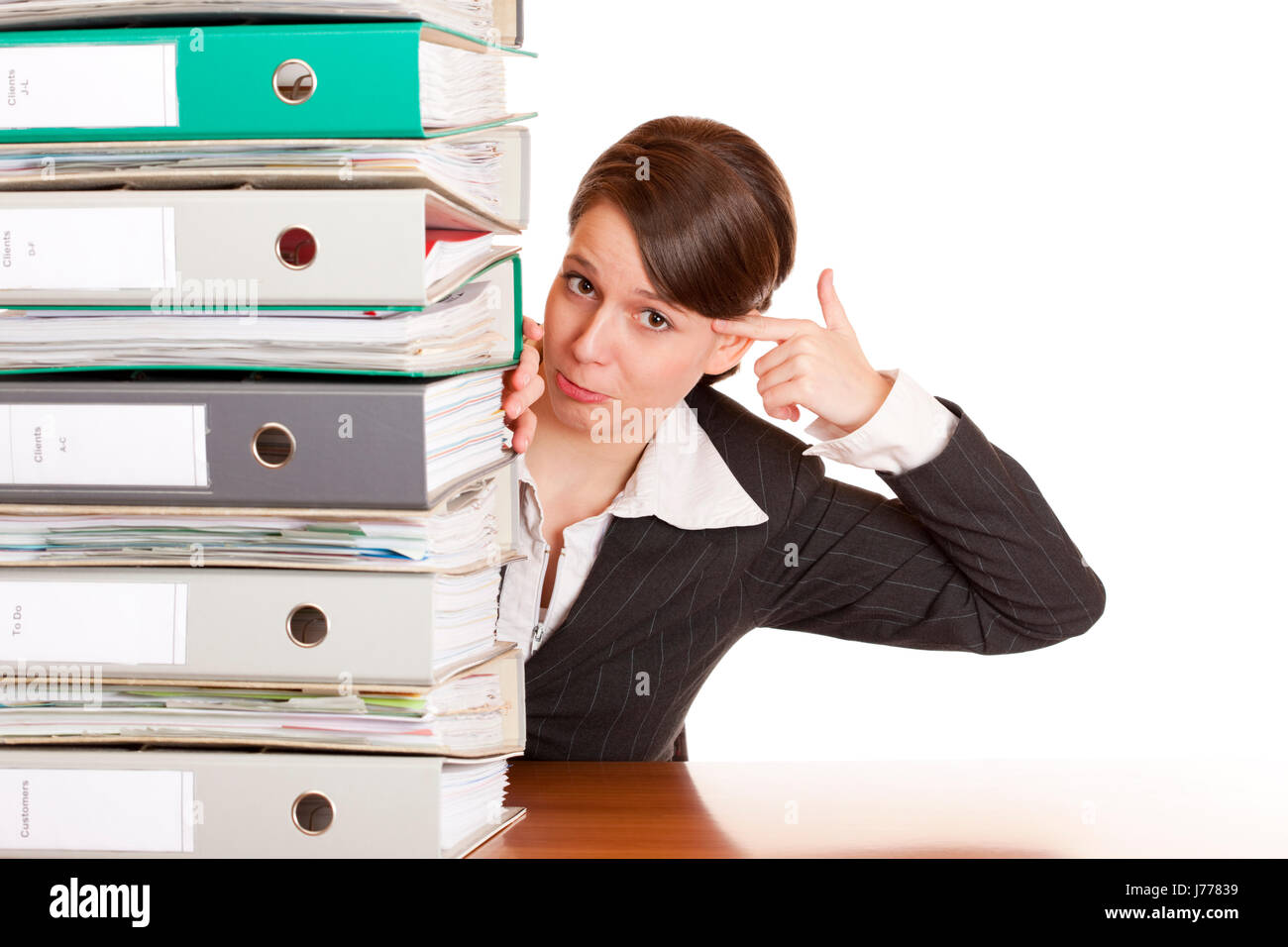 frustrated woman behind file folders Stock Photo - Alamy
