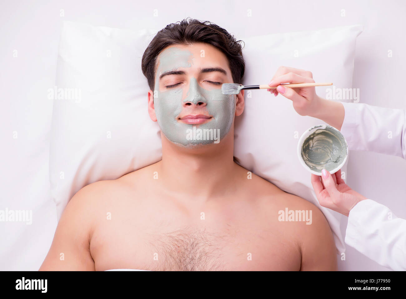 Handsome man in spa massage concept Stock Photo - Alamy