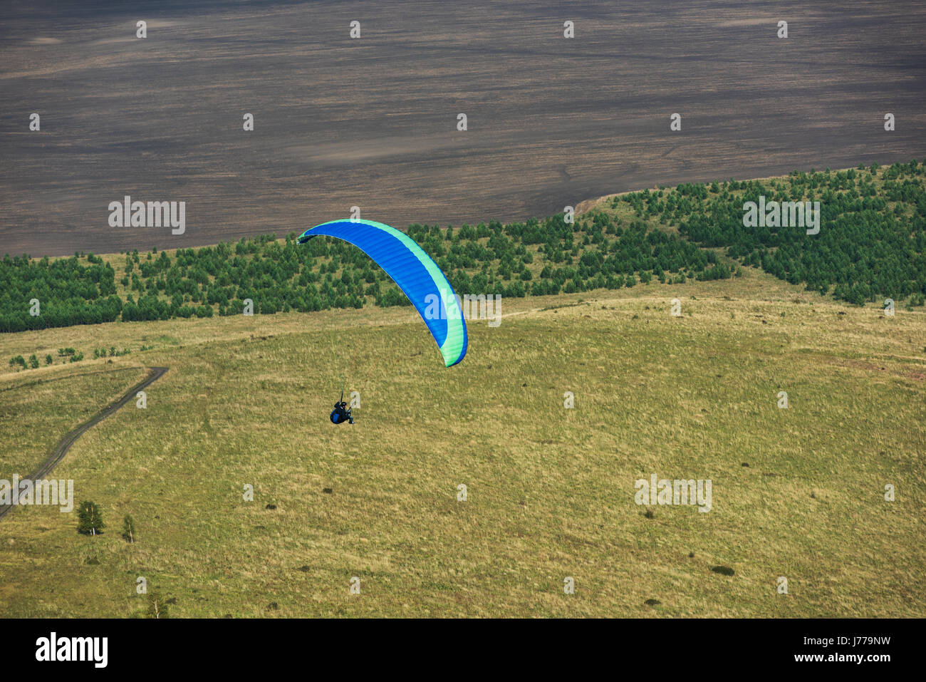 Paragliding in mountains Stock Photo - Alamy