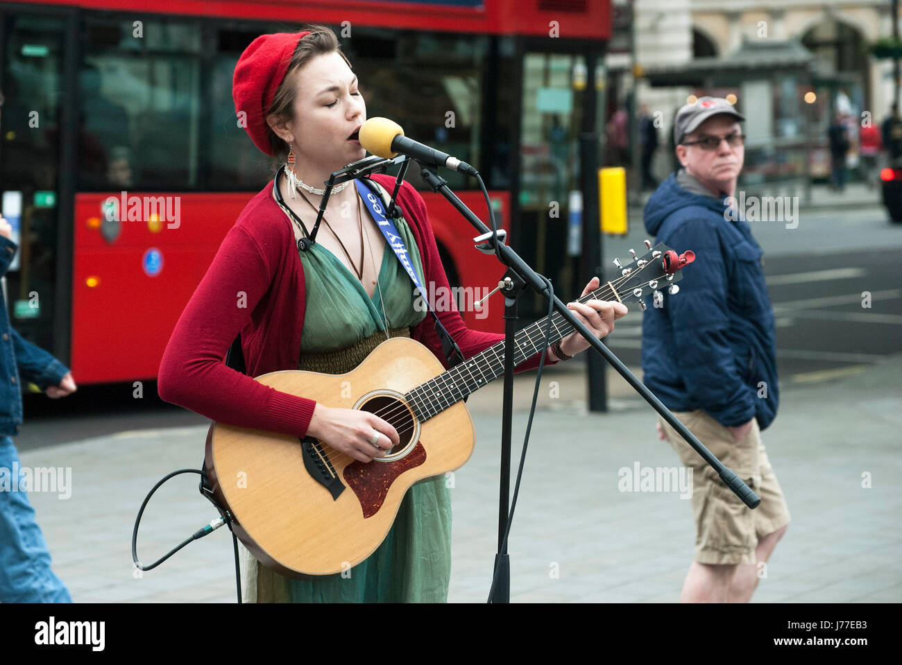 London, UK. 23rd May, 2017. Busker Emily Lee entertains the passing ...