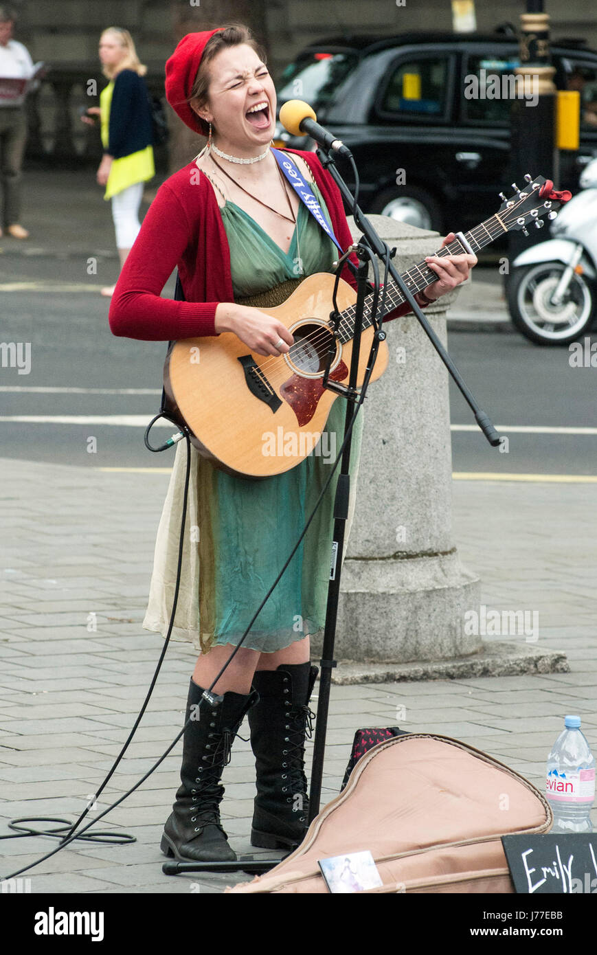 London, UK. 23rd May, 2017. Busker Emily Lee entertains the passing ...