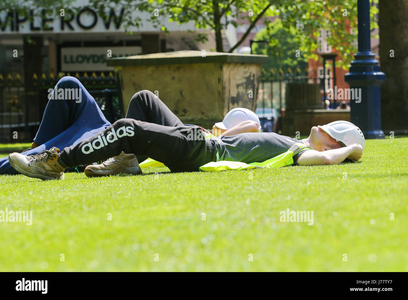 Construction workers taking a break in the park in summer weather Stock ...