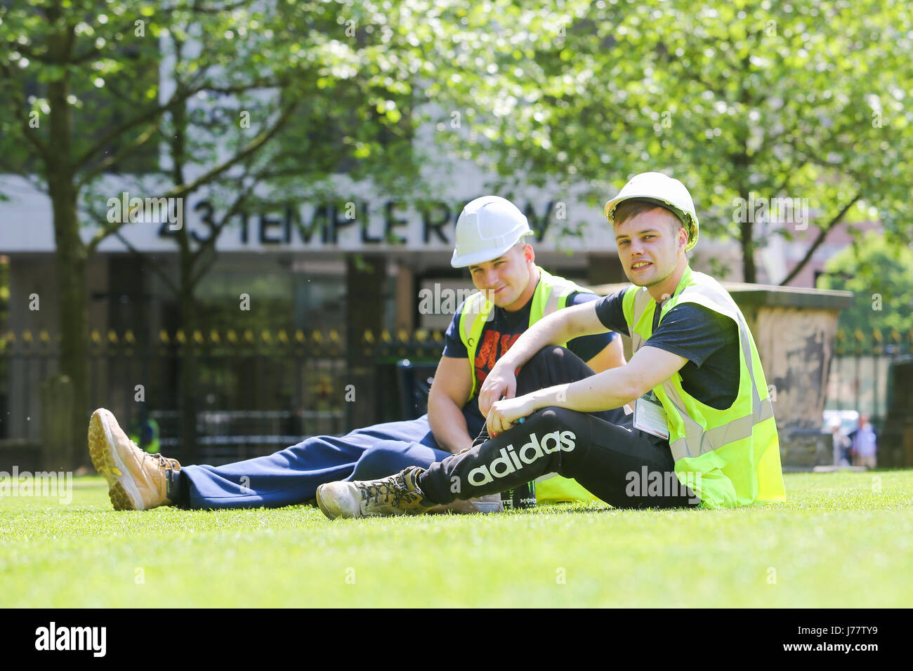 Construction workers taking a break in the park in summer weather Stock ...