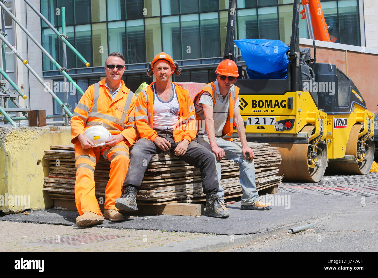Three male construction workers taking a break from work, builders men ... Three male construction workers taking a break from work, builders men ...