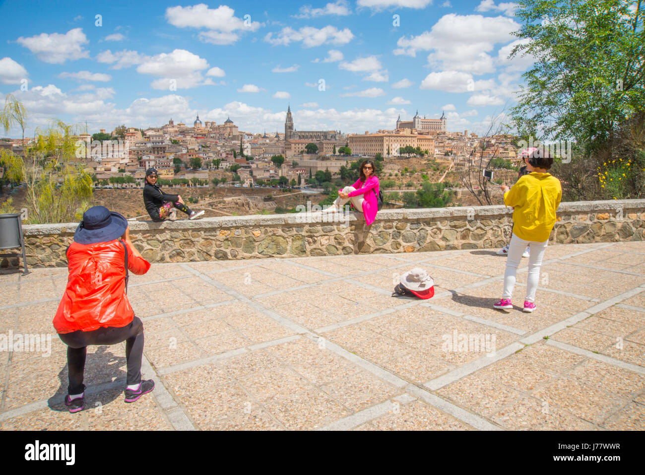 Group of Japanese women taking photos at the viewpoint over the city ...
