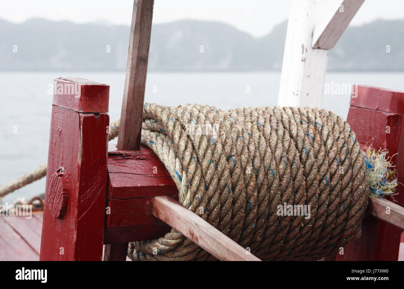 Closeup of fishing boat parking with rope for anchor Stock Photo - Alamy