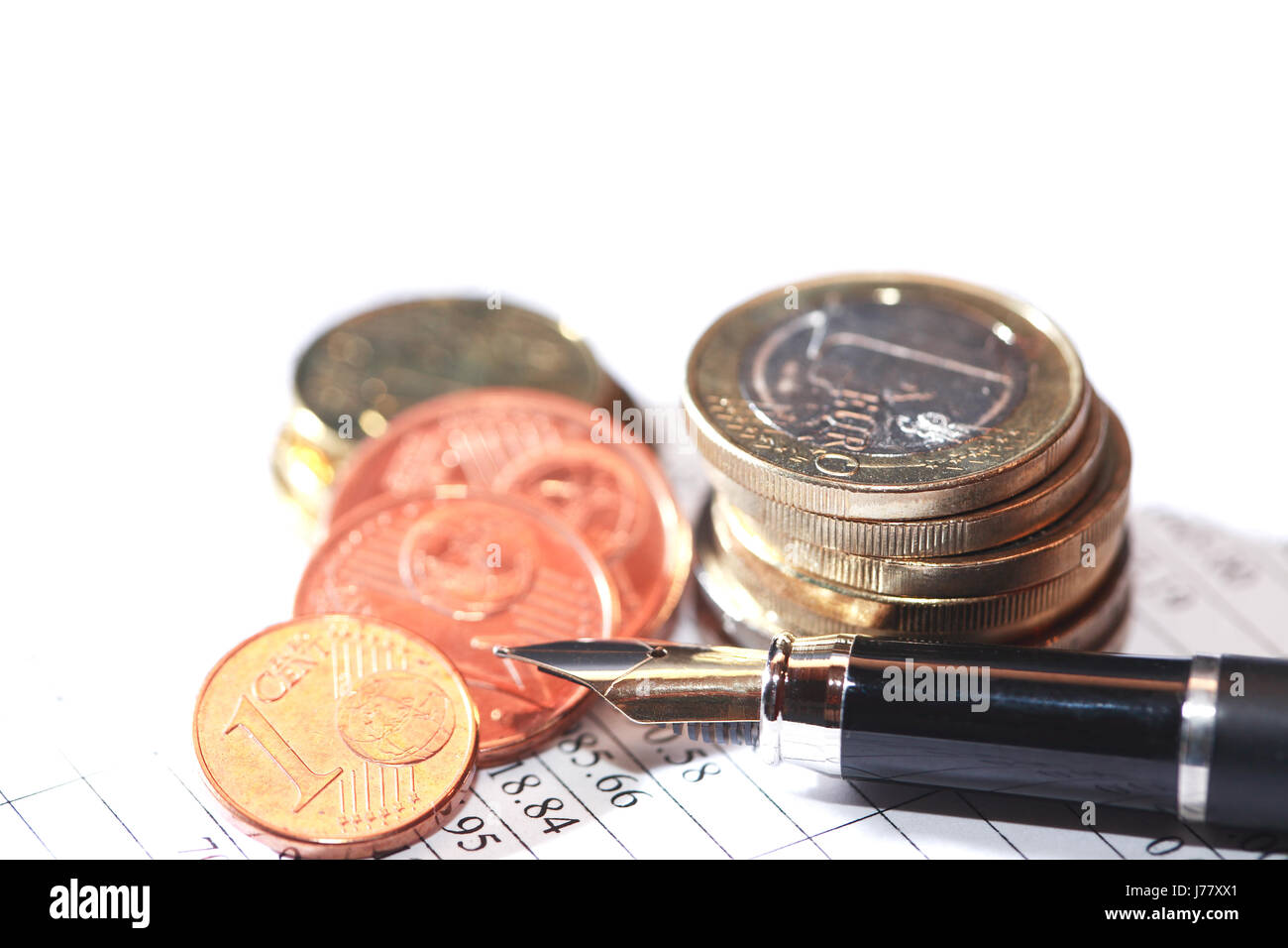 Closeup of coins stack on paper background with digits Stock Photo - Alamy