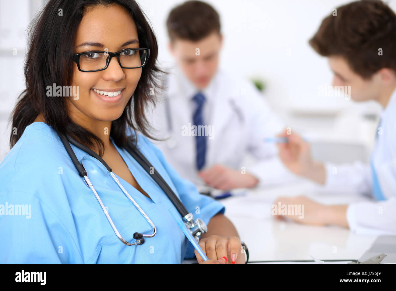 Group of doctors discuss at meeting Stock Photo - Alamy