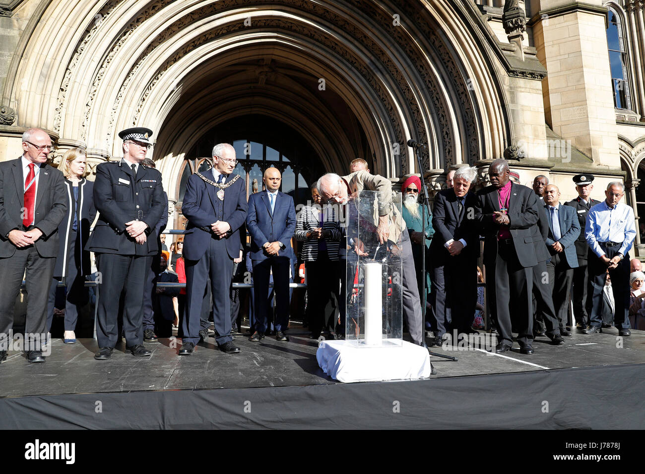 Bishop of Manchester David Walker lights a candle during a vigil in ...