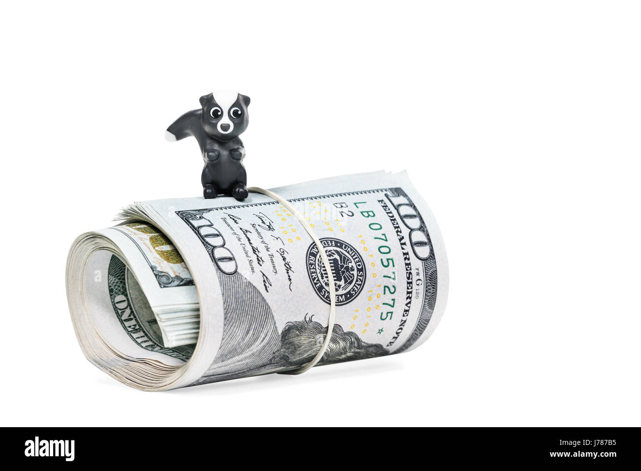 Toy badger on a bunch of money Stock Photo - Alamy