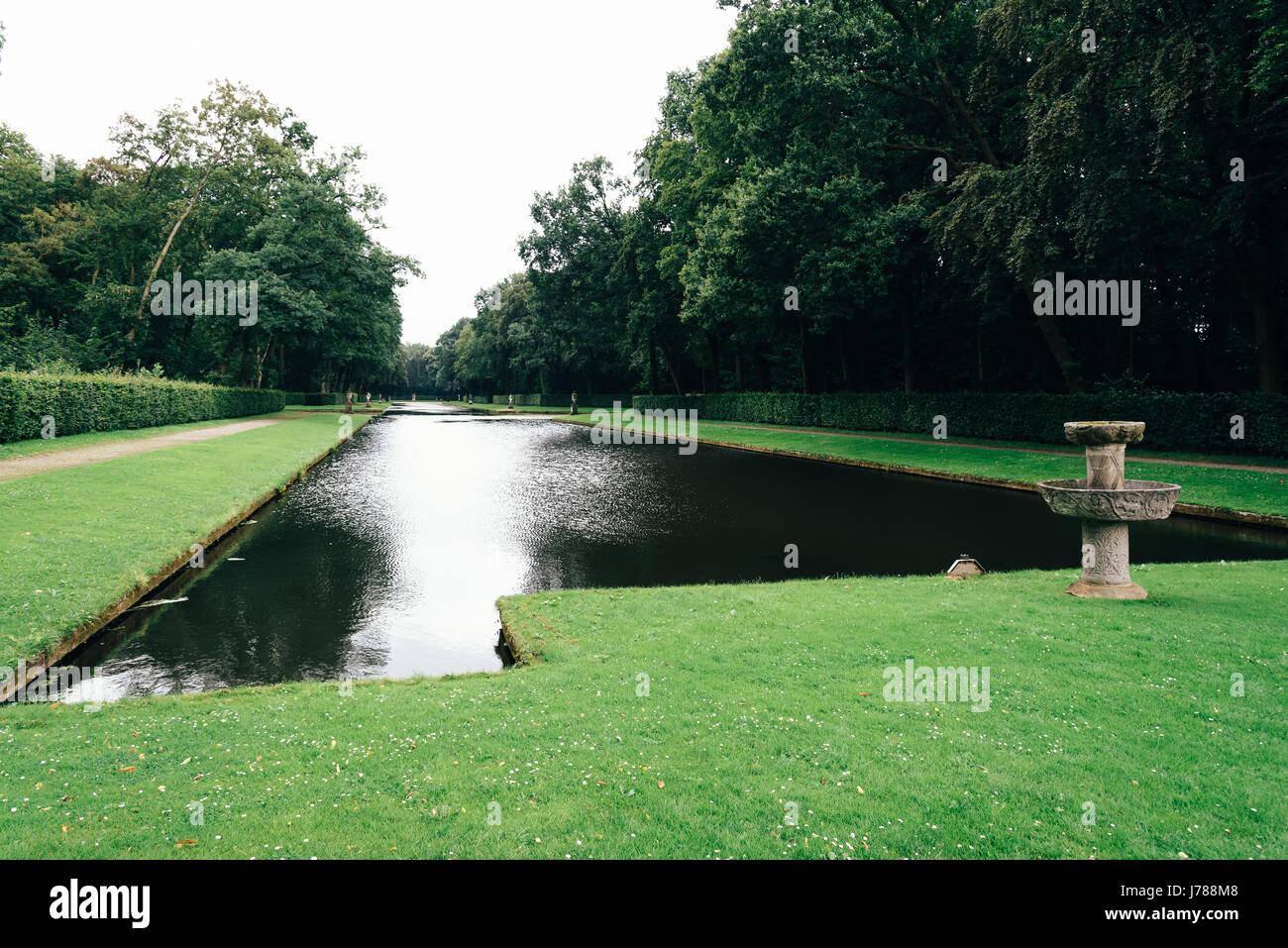 Pond in a formal garden with grass and trees Stock Photo - Alamy