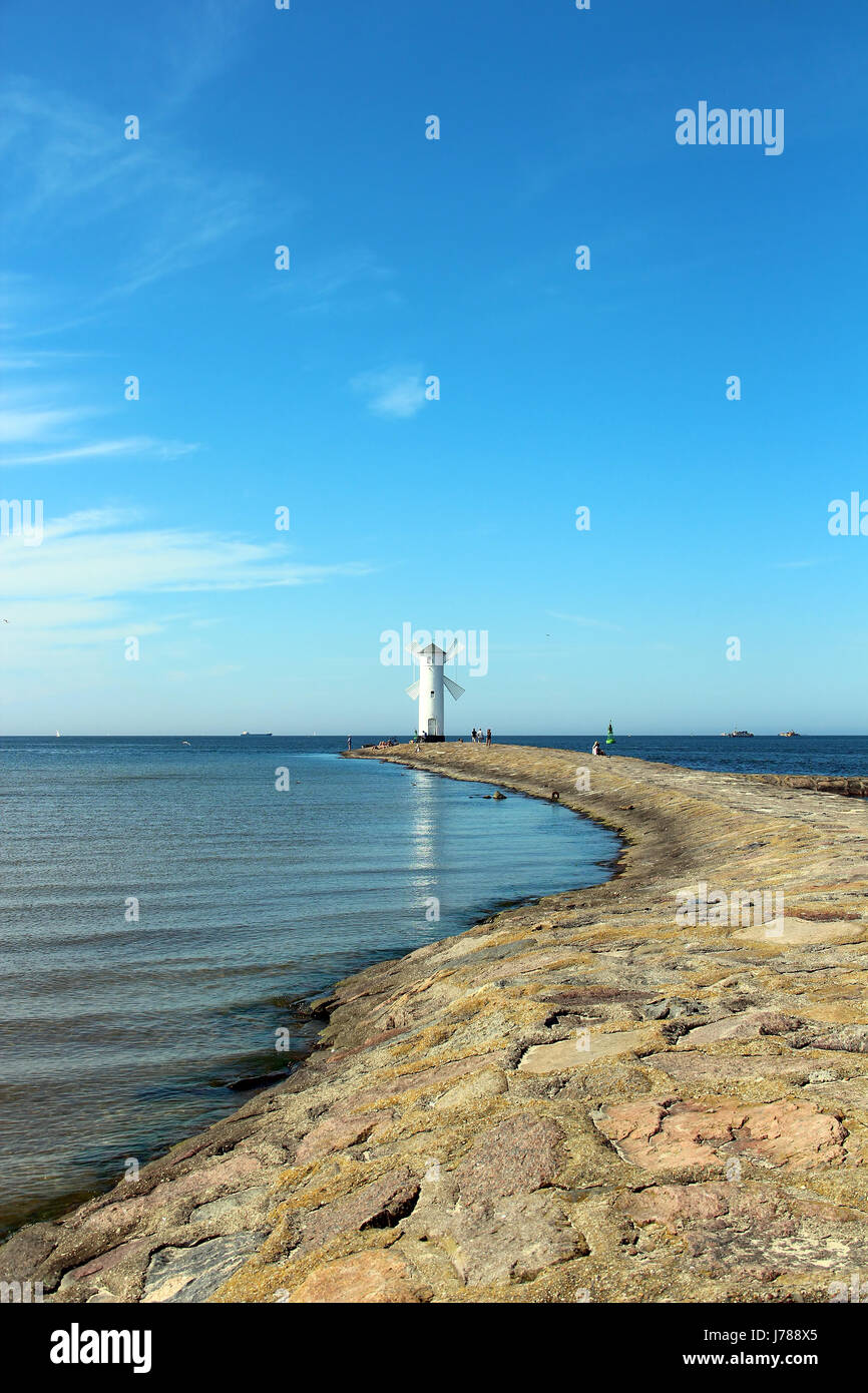 Lighthouse windmill and Baltic Sea in Swinoujscie, Poland Stock Photo ...