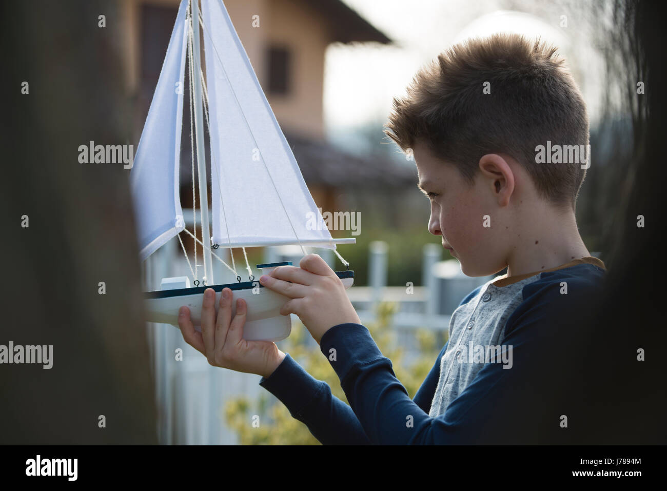 Boy with toy boat Stock Photo - Alamy