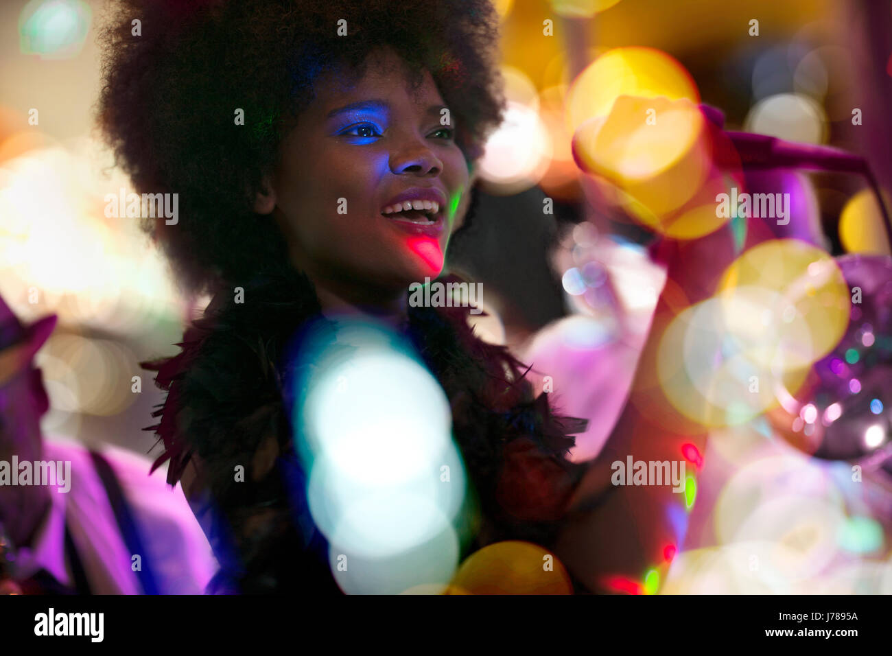 Woman with microphone singing Stock Photo - Alamy