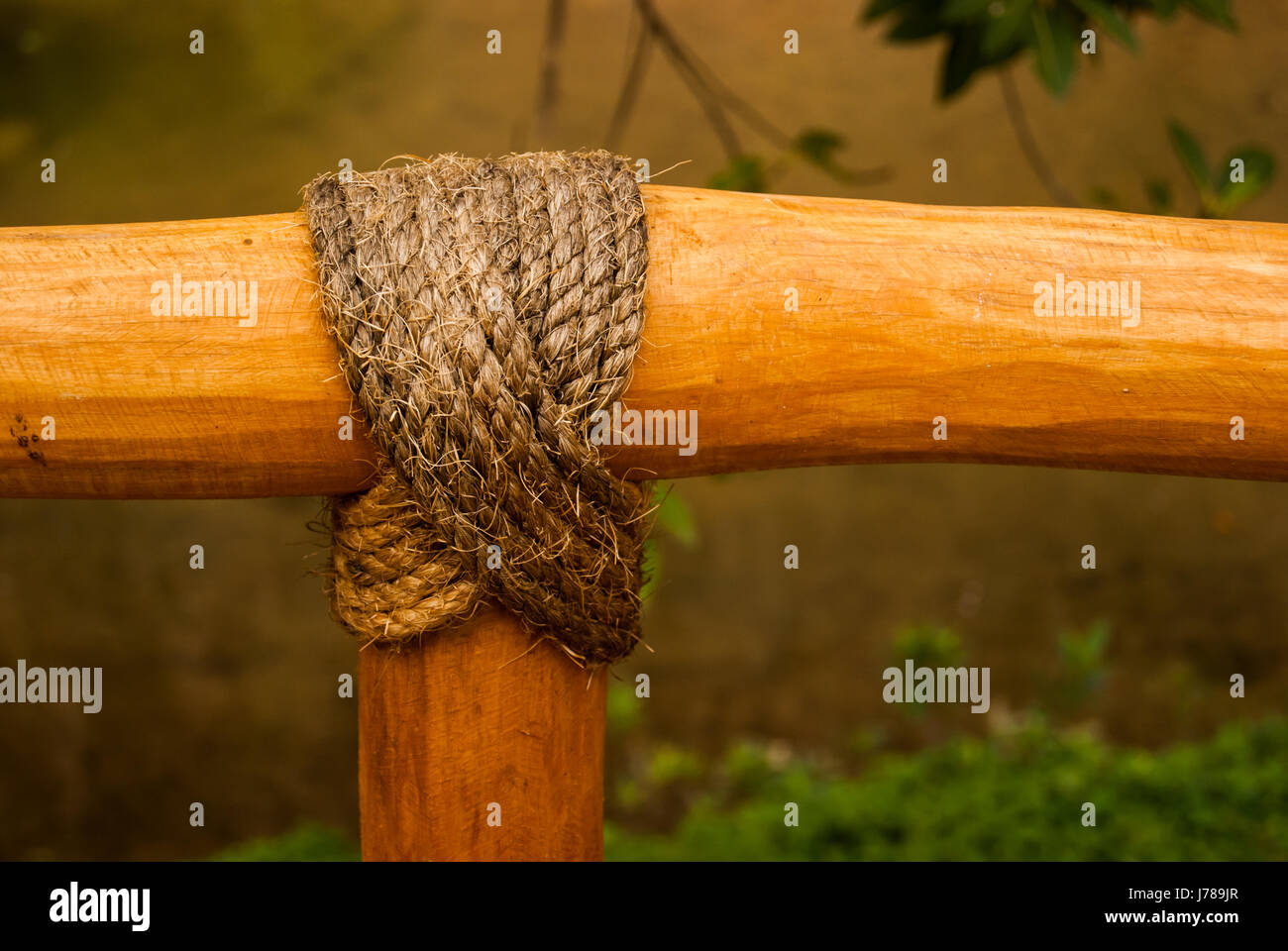 A strong connection of a rail on top of fence post done with a rope as ...