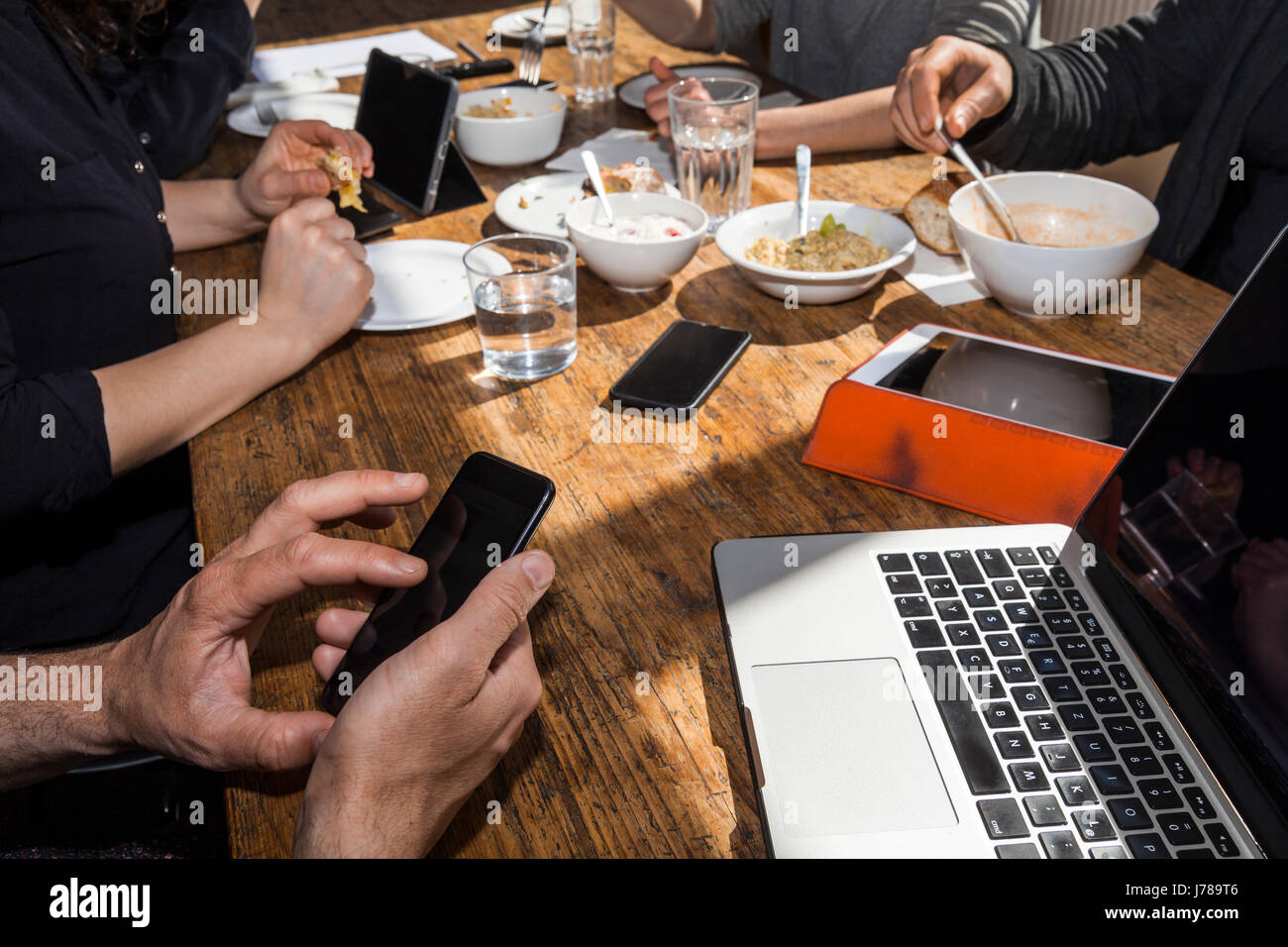 Colleagues having lunch together in the office, partial view Stock ...