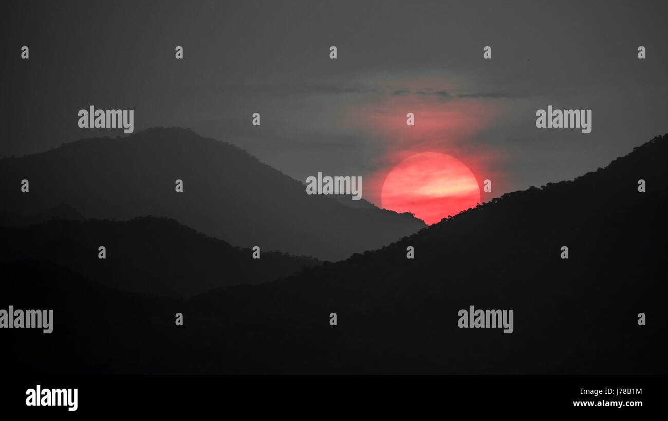 African sunset over mountain range Stock Photo - Alamy