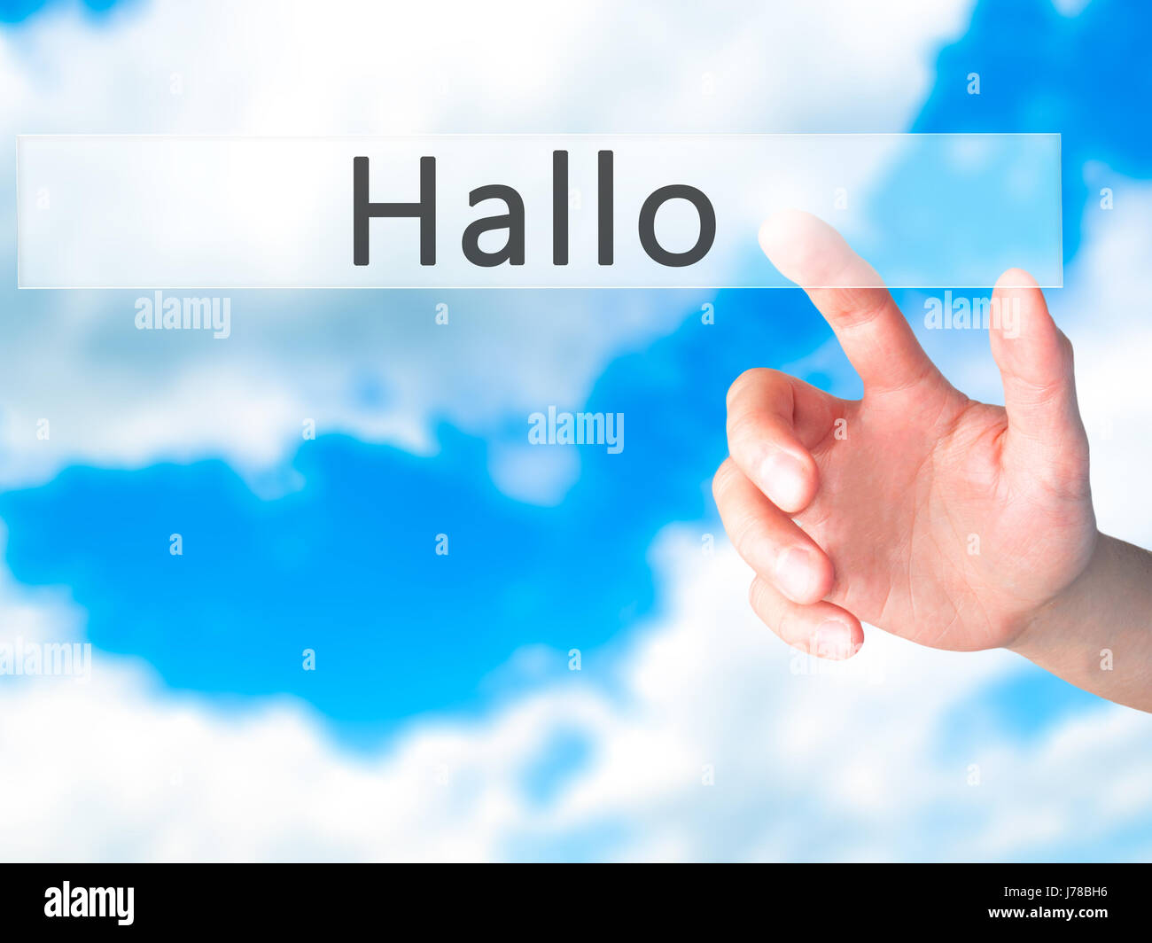 Hallo (Hello in German) - Hand pressing a button on blurred background ...