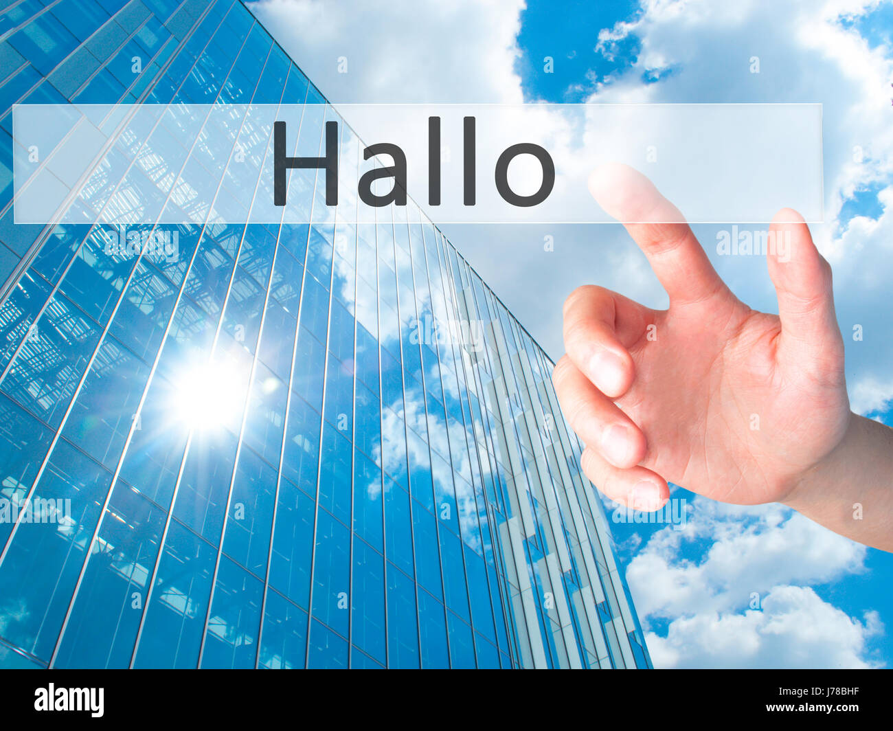 Hallo (Hello in German) - Hand pressing a button on blurred background ...
