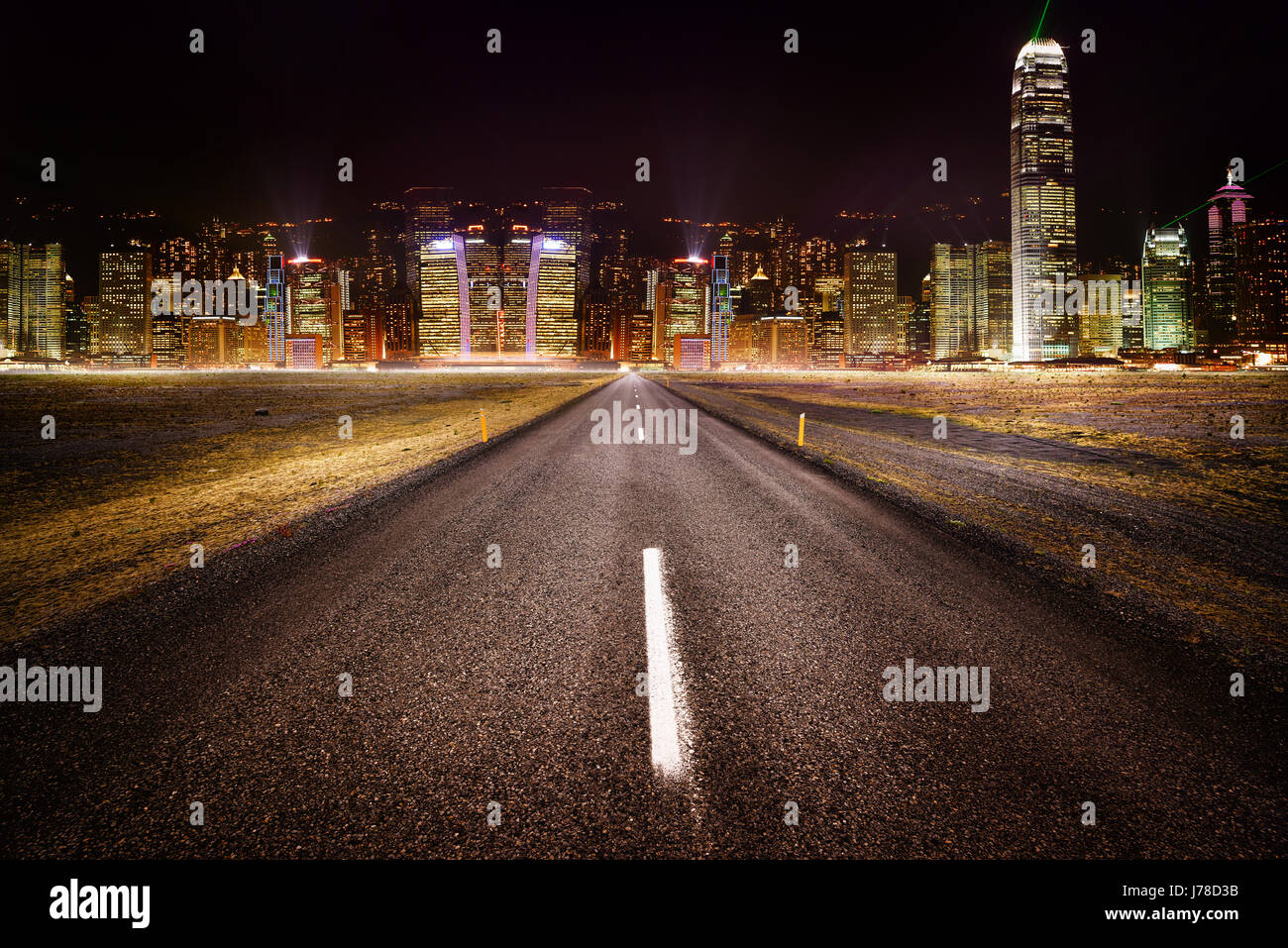 Empty road at night with a city lights in the background Stock Photo ...