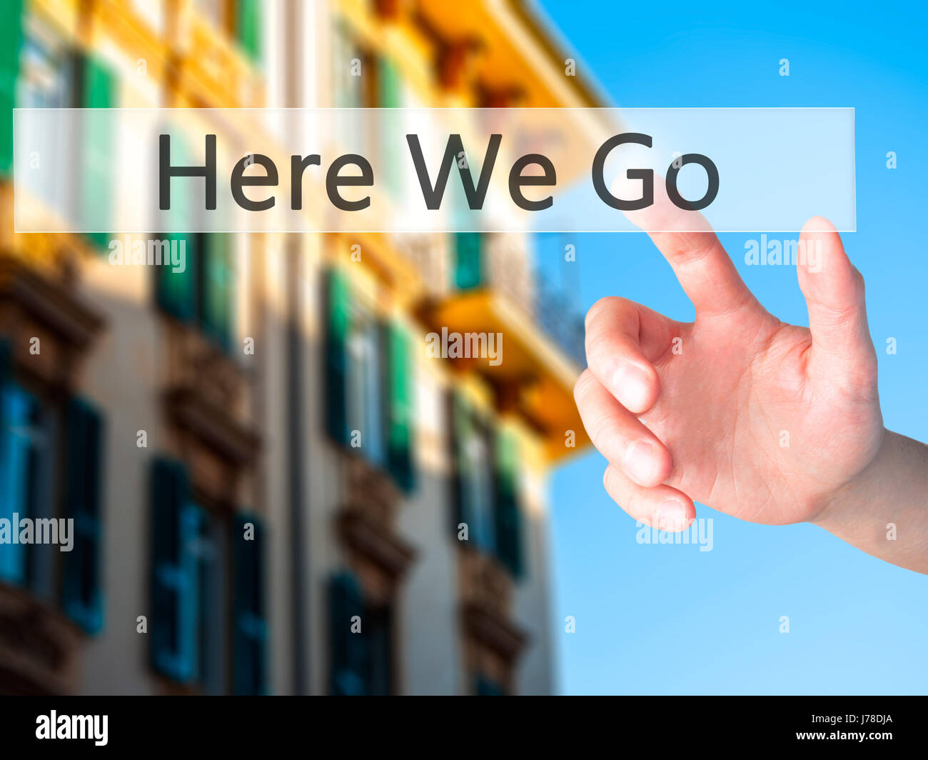 Here We Go - Hand pressing a button on blurred background concept ...