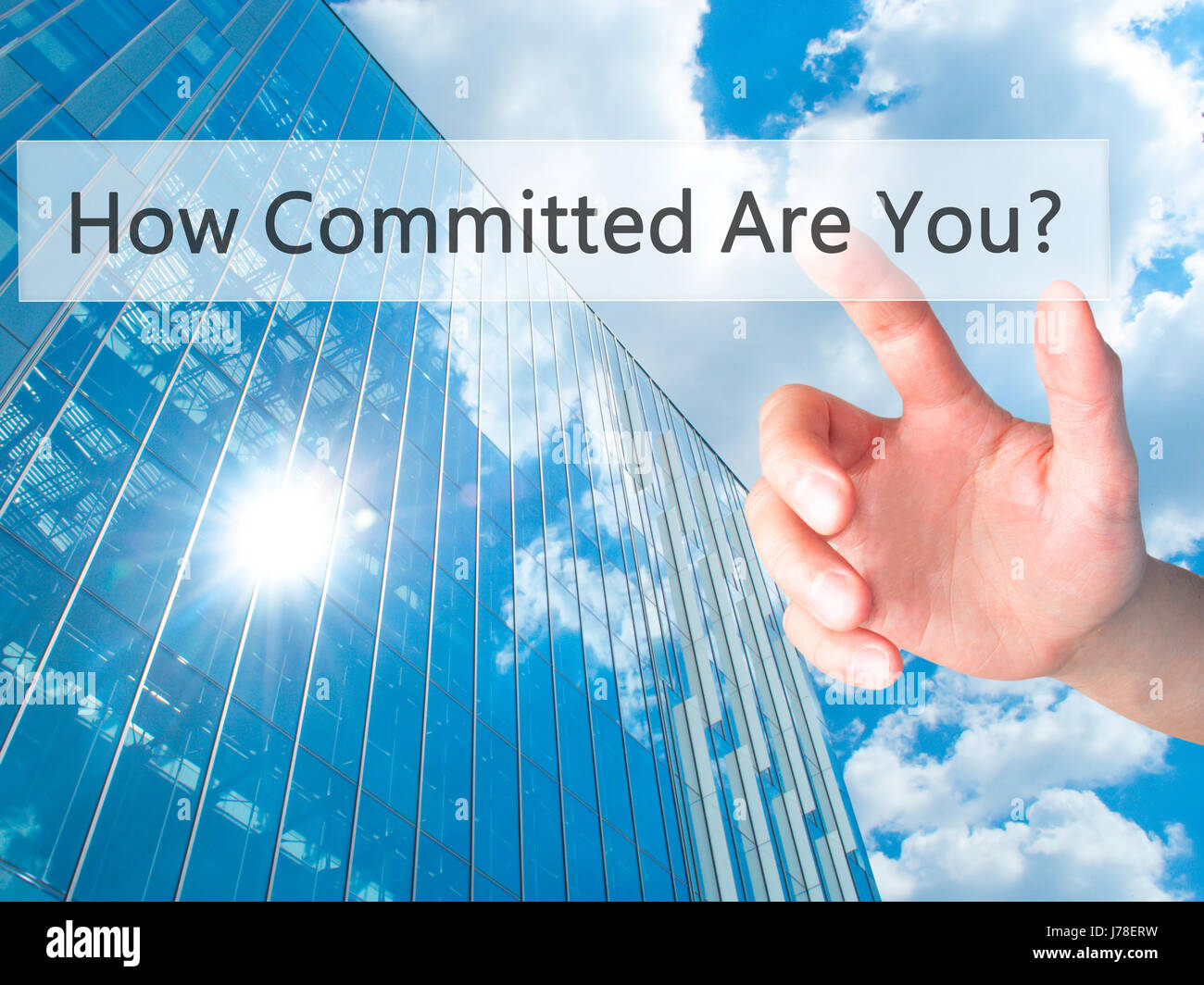 How Committed Are You - Hand pressing a button on blurred background ...