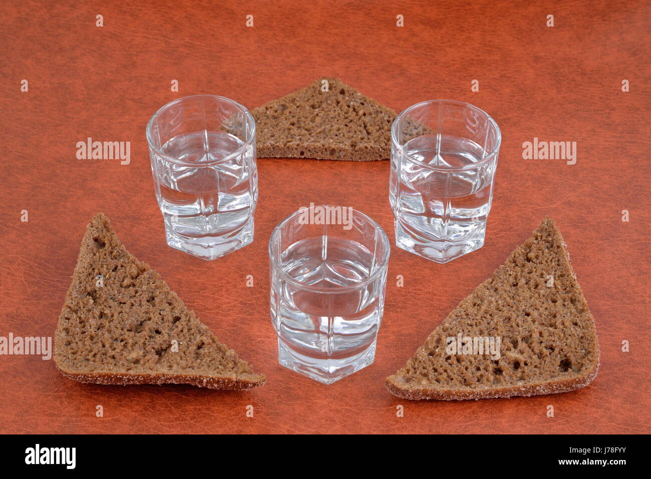 Shots of vodka and pieces of black bread on the table Stock Photo - Alamy