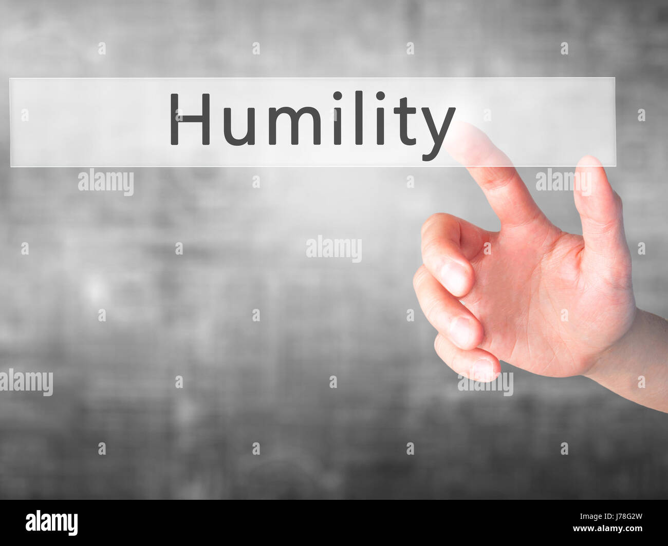 Humility - Hand pressing a button on blurred background concept ...