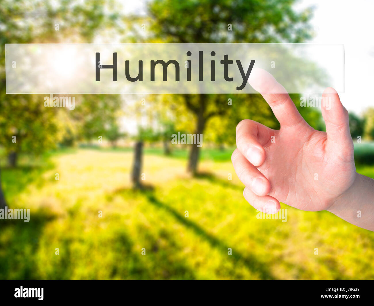 Humility - Hand pressing a button on blurred background concept ...